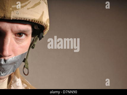 Soldier with his mouth taped over. Soldier is wearing British Military ...