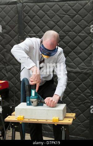 man demonstrating dust extraction on power tool Stock Photo - Alamy