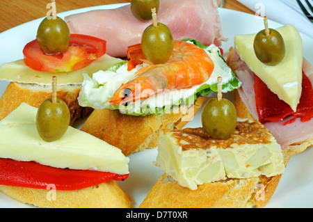 Selection of Spanish tapas served on a sliced baguette Stock Photo - Alamy