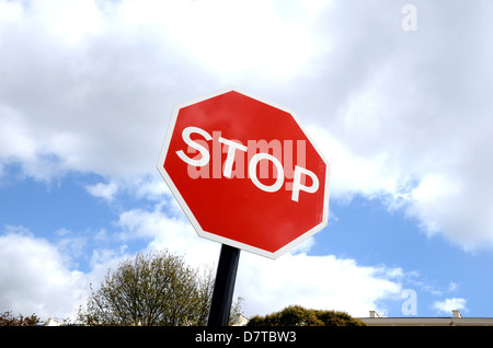 Octagonal red stop sign at a UK road junction Stock Photo - Alamy