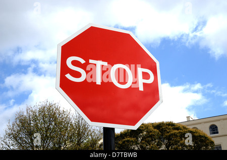 Octagonal red stop sign at a UK road junction Stock Photo - Alamy