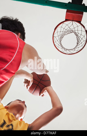 Young professional basketball player defending the ball from attack of ...