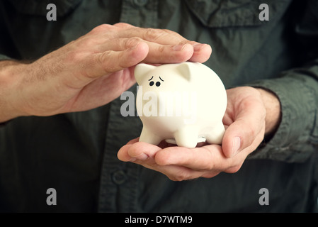Business man with a coin in his hands and a puzzled look gesticulate ...