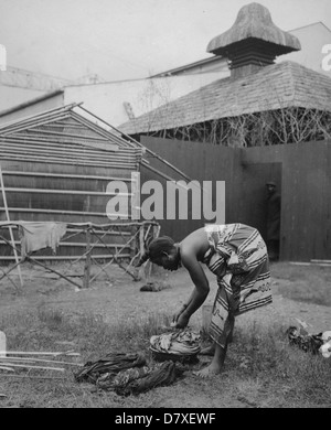 African american woman washing clothes at laundry room Stock Photo - Alamy