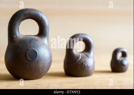 Three small calibration weights standing on wooden background Stock ...