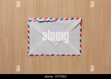 An air mail envelope slightly worn and torn Stock Photo - Alamy