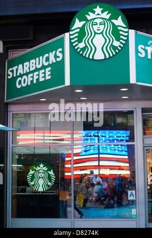 Starbucks coffee shop Times Square with reflection of flag in window ...