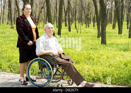 Elderly amputee with one leg amputated above the knee being taken for a ...