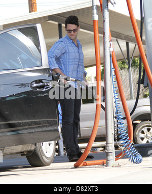 Justin Bartha fills up his car at the gas station Hollywood, California ...