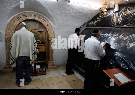 Religious Jews pray at the underground chamber synagogue underneath ...