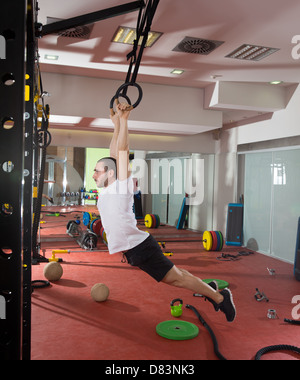 Crossfit fitness dip ring swing exercise man workout Stock Photo - Alamy