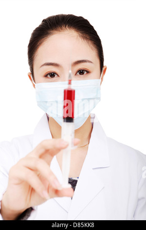 young asian female doctor holding tablet talking on smartphone in ...