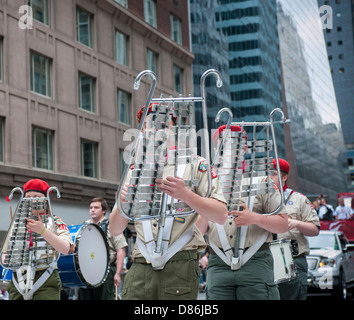 A band of boy scouts in uniforms marching in an independence day parade ...
