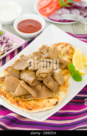 Donner Meat on Naan - Slices of donner meat on top of a flatbread ...