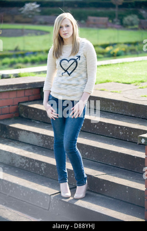 Pretty woman standing on steps Stock Photo - Alamy