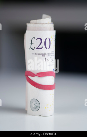 A roll of twenty pound notes on a table Stock Photo - Alamy