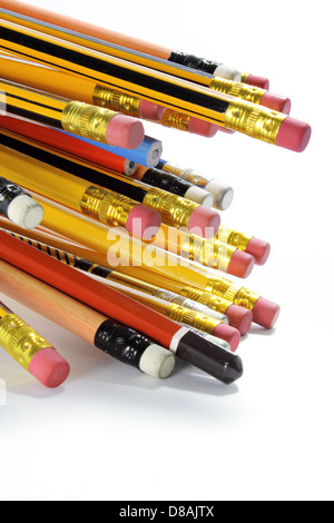 Vertical closeup shot of pencils and an eraser on a white background ...