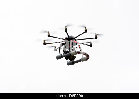 Drone with digital camera flying on sunny sky. Modern RC quadcopter ...