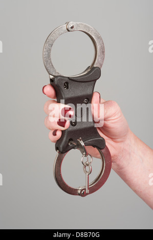 Police issue handcuffs with key in lock Stock Photo - Alamy