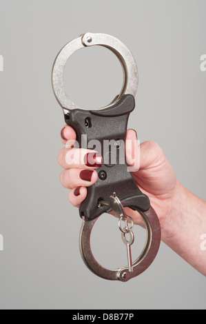 Police issue handcuffs with key in lock Stock Photo - Alamy