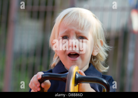 Blond kid crying very loud on the street Stock Photo - Alamy