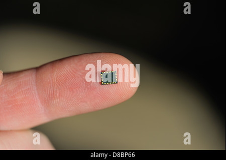 Miniature MEMs device on human finger Stock Photo - Alamy