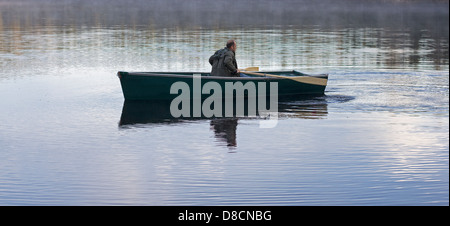 man rowing on a calm wild lake Stock Photo - Alamy