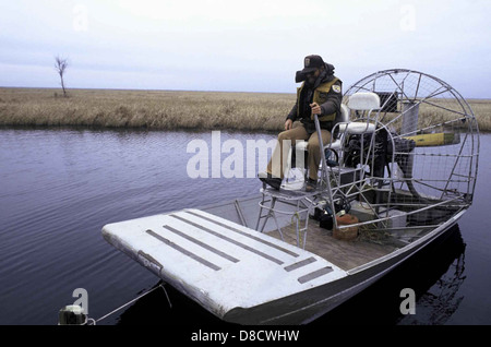 A man navigating an airboat through the waters of Tallahassee, Florida ...
