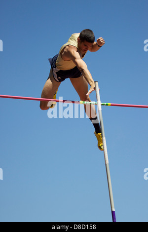 Man clears the bar pole vaulting Stock Photo - Alamy