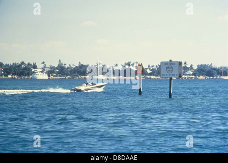 Speed Boat racing through idle speed zone area in water designated as ...