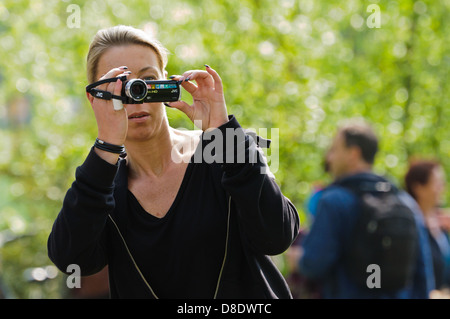Blond woman videotaping with a JVC camcorder Stock Photo - Alamy