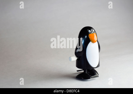 A small plastic wind up toy Penguin Stock Photo - Alamy