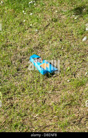 Discarded empty Doritos crisp packet on grass in public area Stock ...