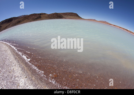 The blue Lagoon on the foothills of the Uturuku Volcano in the Bolivian ...