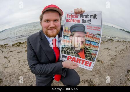 Bastian Langbehn, member of "Die Partei" poses with an election poster ...