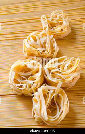 Italian pasta vertical background. Uncooked "bow-tie pasta" (farfalle ...