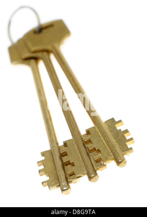 Three gold keys. It is isolated on a white background Stock Photo - Alamy