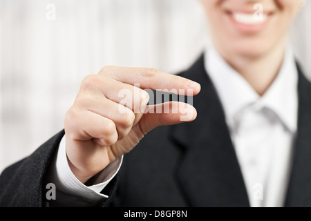 Businesswoman pinching finger sign Stock Photo - Alamy