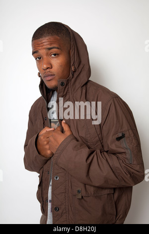 Hooded Male Holding Head in Hands Stock Photo - Alamy
