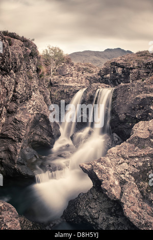 A long exposure shot of a cascade waterfall coming down the big rocks ...