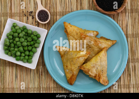 Vegetarian samosas and green peas, close up Stock Photo - Alamy
