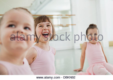 Children sitting on floor practicing the splits in ballet school Stock ...