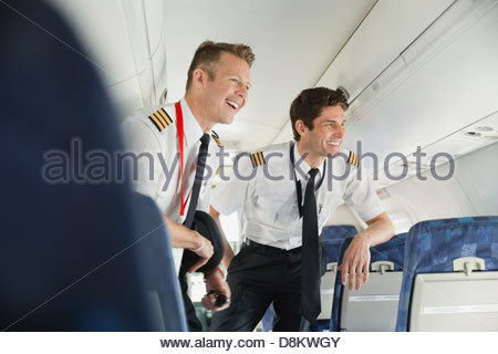 Male pilot and co-pilot looking out window in airplane cabin Stock ...