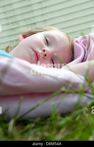 Little girl napping outdoors Stock Photo - Alamy