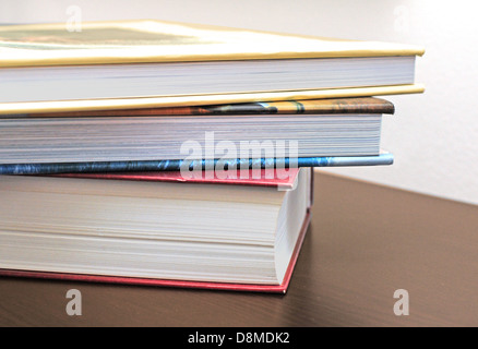 side-on view of a stack of books, portrait photograph, white Stock ...
