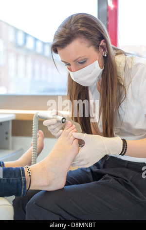 pedicure grinding toe nails of customer Stock Photo - Alamy