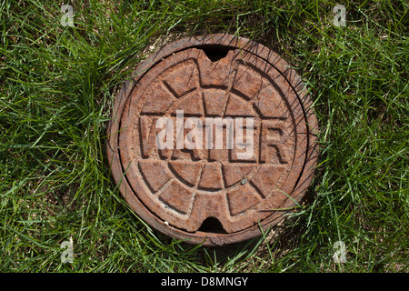 A small water utility cast iron cover is set in the lawn Stock Photo ...