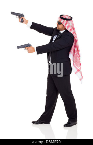 middle eastern bodyguard posing with guns on black background Stock ...
