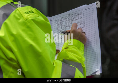 British Police officer writing notes in his pocket book wearing a Stock ...