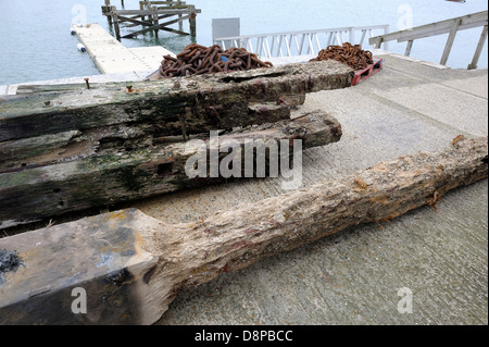 Rotting wooden piles from an old boat landing stage on the beach near ...